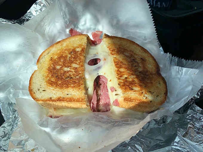 Even wrapped to go, this Reuben looks like it's about to make someone's entire day better.