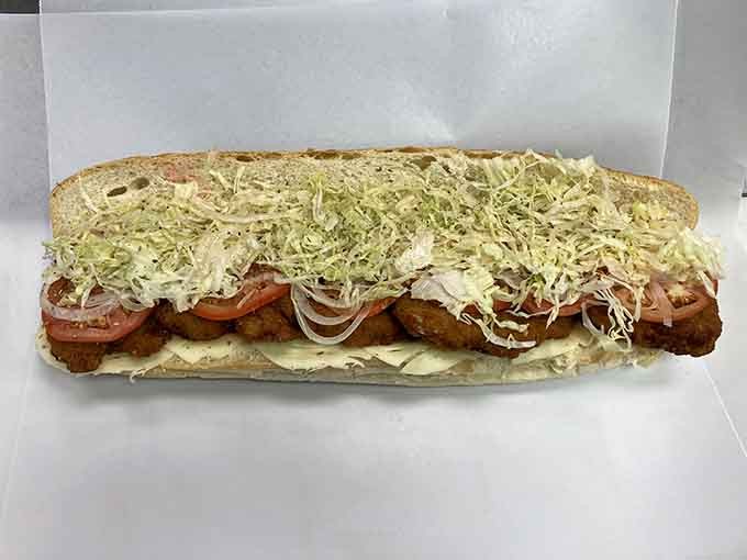 That chicken sub is loaded with enough toppings to require structural engineering, and we're absolutely here for it.