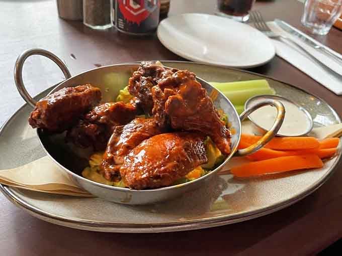 Wings glazed to perfection in their little copper serving dish, accompanied by fresh veggies that probably won't get eaten but look nice anyway.