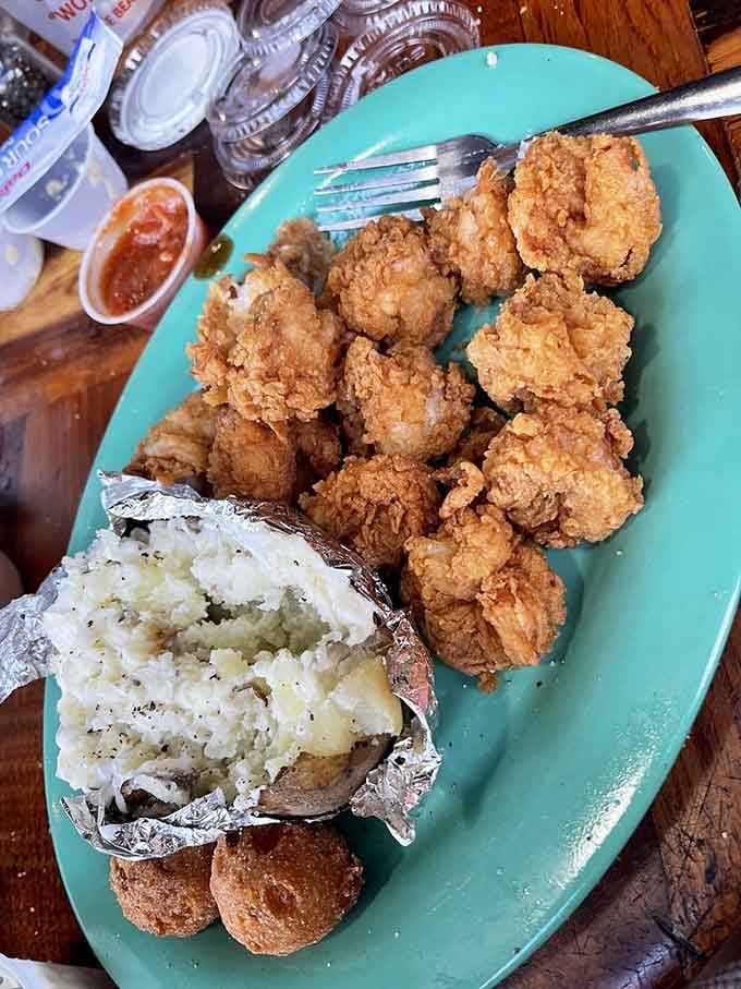 That perfectly seasoned baked potato sitting next to golden fried shrimp is the supporting actor that steals scenes.