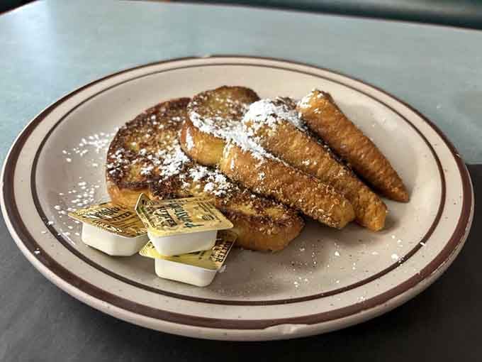 French toast dusted with powdered sugar and served with butter proves simple perfection never goes out of style.