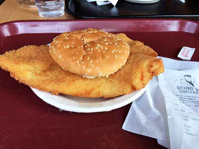 That fish sandwich is so generously portioned, the bun looks like it's attempting a heroic rescue mission.