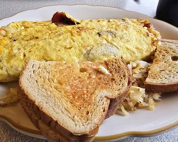 Fluffy eggs folded around melted cheese with golden toast on the side is comfort food that's been perfected over generations.