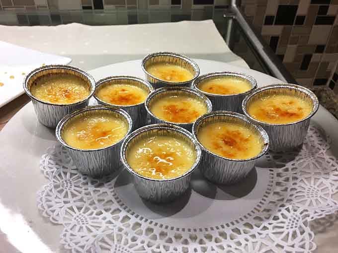 Individual cr&egrave;me br&ucirc;l&eacute;es wait patiently for someone to crack through that caramelized sugar top with a spoon.