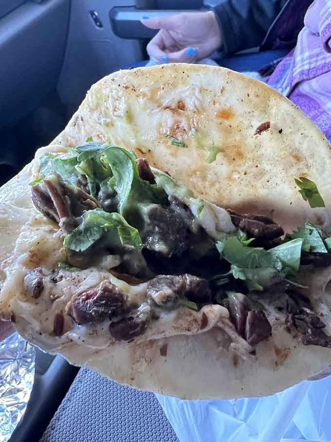 Car dining never looked this good: tender carne asada nestled in a handmade tortilla with fresh cilantro and melted cheese.
