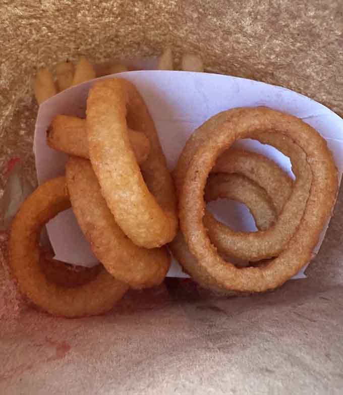 Onion rings with the kind of crunch that echoes across the parking lot, announcing your excellent choices.