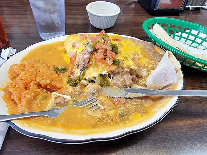 This chile relleno swimming in green chile sauce is basically a warm, cheesy hug that happens to be delicious.