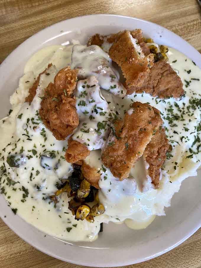 Even lunch gets the royal treatment with crispy chicken strips perched atop fresh salad like edible treasure.