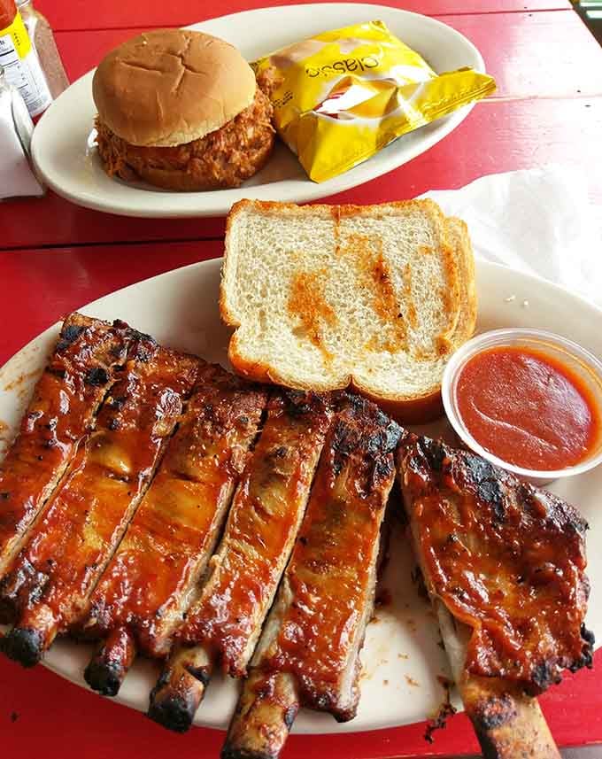 The dynamic duo of barbecue: ribs that fall apart and a pulled pork sandwich ready for action.