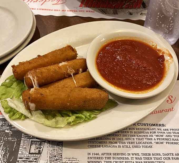 Golden-fried mozzarella sticks with that legendary marinara sauce for dipping, because some appetizers are non-negotiable when dining Italian-American style.