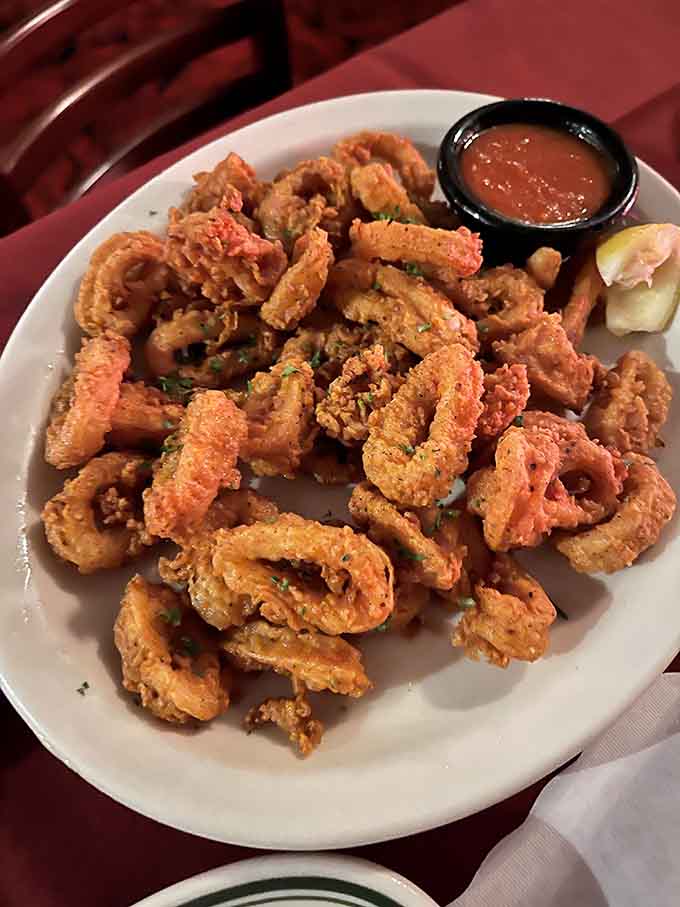 Golden fried calamari piled high, crispy and tender, the kind of appetizer that disappears faster than good intentions.