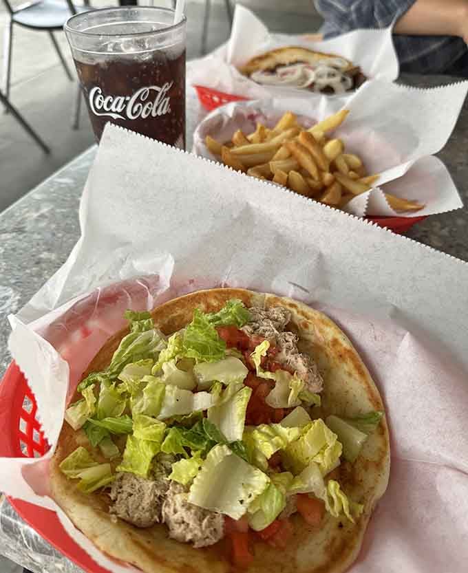 The gyro arrives like a Mediterranean vacation wrapped in pita, minus the expensive plane ticket and jet lag.