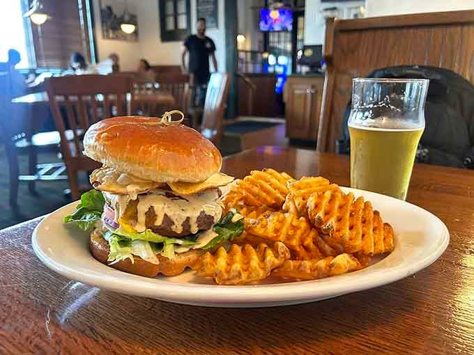 A burger with waffle fries and a beer, the holy trinity of brewpub dining done absolutely right.