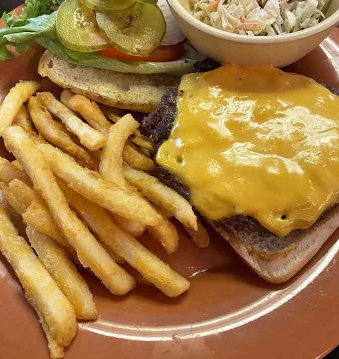 That cheese blanket draped over the burger looks like it's tucking the patty in for a delicious nap.