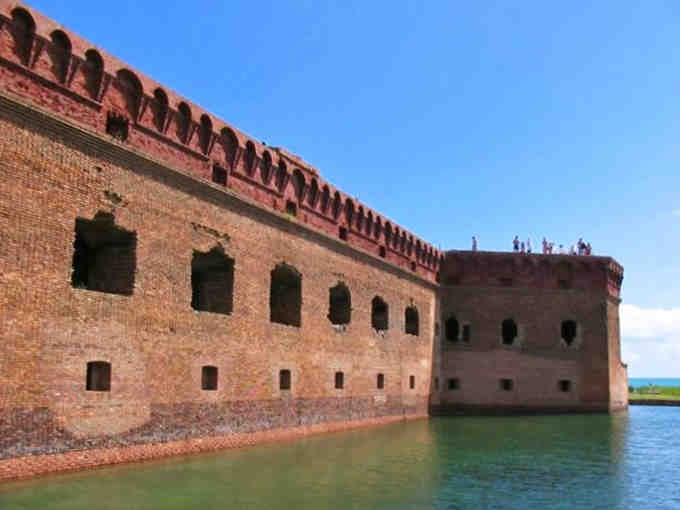 Those fortress walls rise from the moat like a brick giant taking a very long, very scenic bath.