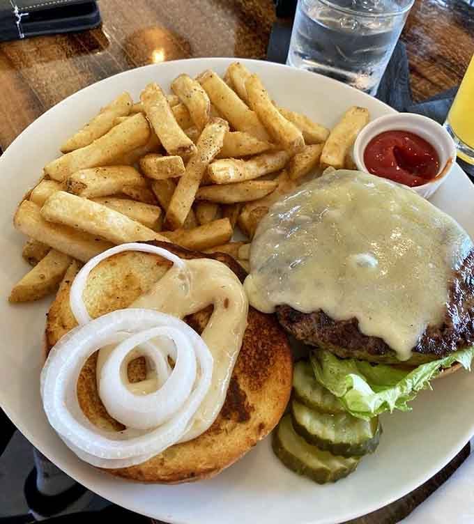 When your burger needs its own structural support system, you know you've ordered correctly and regret means nothing here.