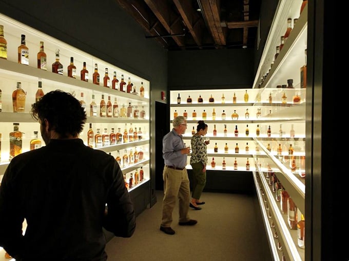 These illuminated bourbon bottles glow like precious gems, each one telling its own story of Kentucky craftsmanship.