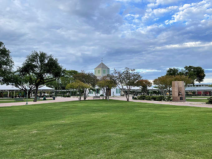 Green lawns and white pavilions create a peaceful plaza where history and relaxation meet under endless blue.