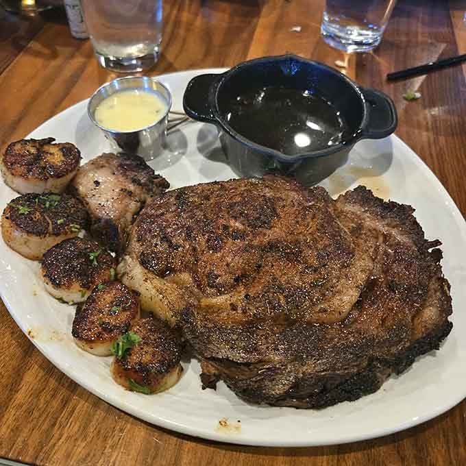 Prime rib and scallops share the plate like old friends, accompanied by au jus that makes every bite better.