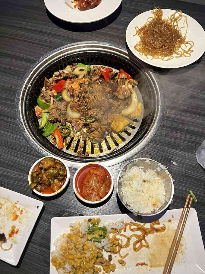 Beef bulgogi bubbling away with vegetables, creating the kind of aromatic magic that makes neighbors suddenly very friendly.