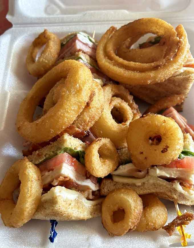 That club sandwich stacked high with crispy onion rings shows George's doesn't play favorites between lunch options.