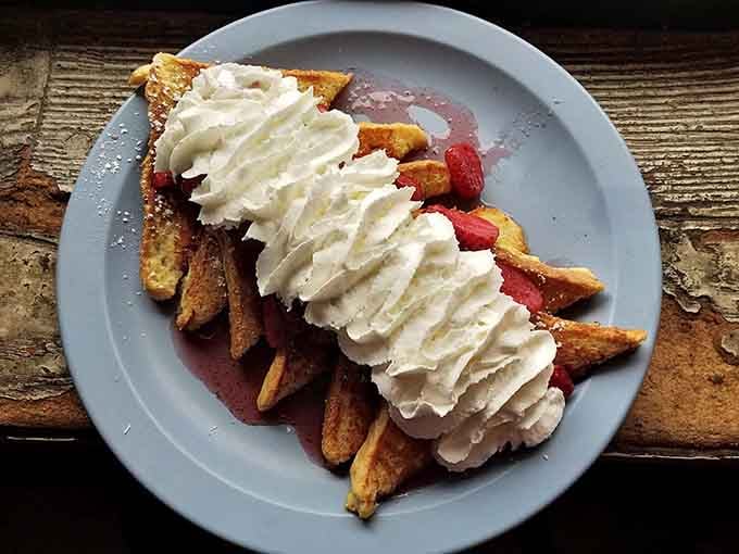 French toast topped with strawberries and whipped cream, because sometimes you need dessert disguised as breakfast and nobody's judging.