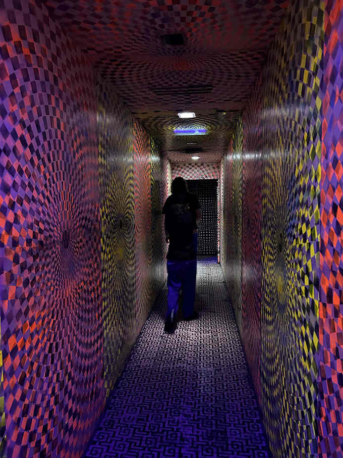 This psychedelic hallway makes you question reality before the scares even start, which is honestly pretty clever design work.