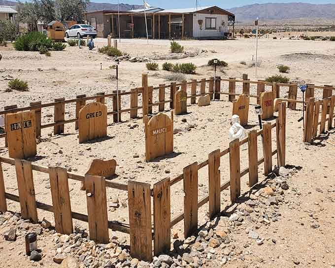 This folk art graveyard features headstones with names that suggest humor survives even in memorial form.