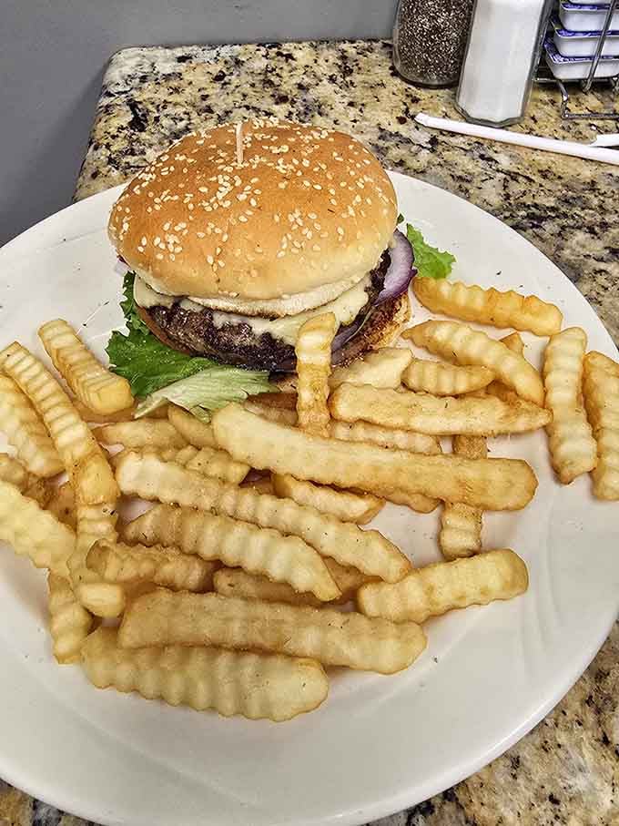 Sesame seed bun, juicy patty, waffle fries standing at attention like little soldiers ready for duty on your taste buds.