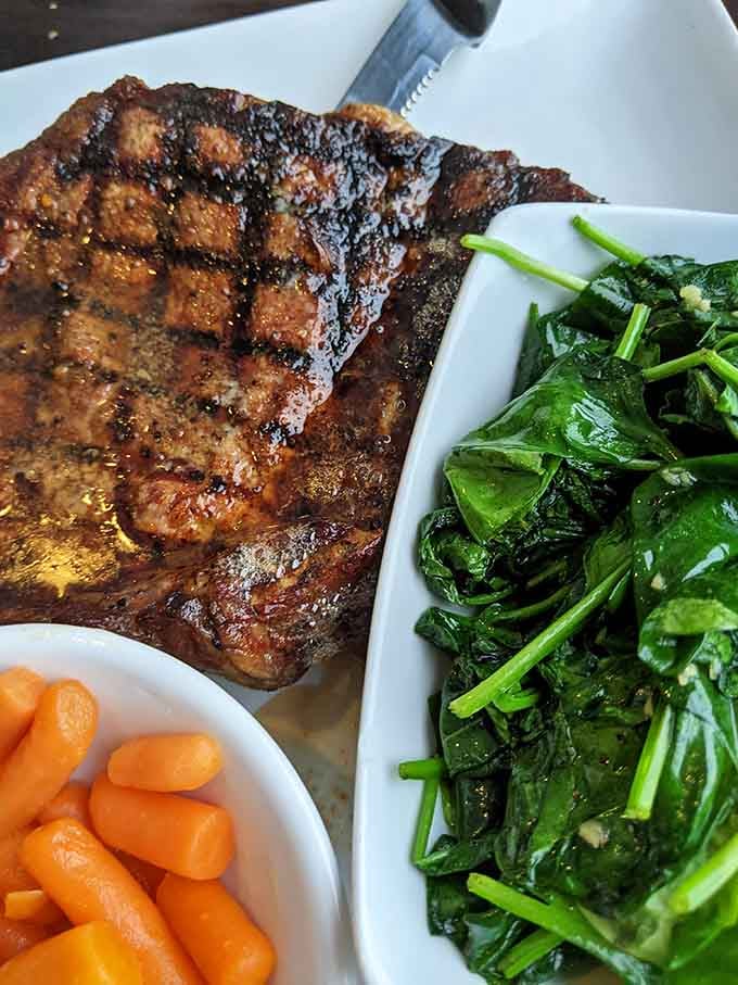 That cowboy cut ribeye brings enough marbled, bone-in beauty to make any carnivore weak in the knees instantly.