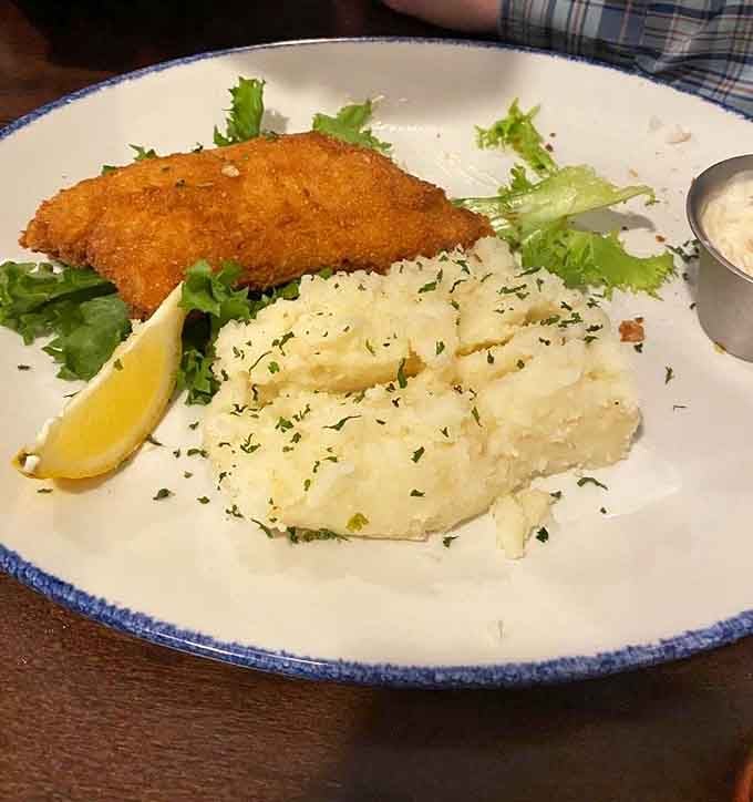 That breaded cod stretches across the plate like it's trying to escape, bringing friends like green beans along.