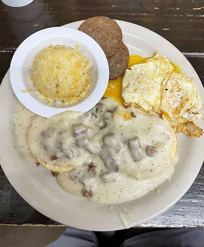 Biscuits drowning in sausage gravy, proving that some of life's best moments involve carbs and more carbs.