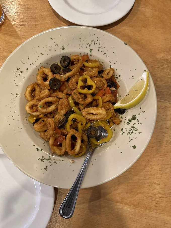 Tender calamari rings tossed with olives and banana peppers, bringing Mediterranean sunshine to your Massachusetts table.