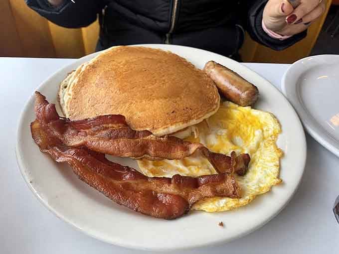 This is what happens when pancakes, eggs, bacon, and sausage have a family reunion on your plate.