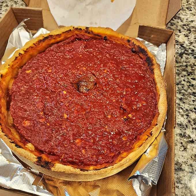 That buttery crust holding back a sea of sauce and cheese like a delicious structural engineering marvel.