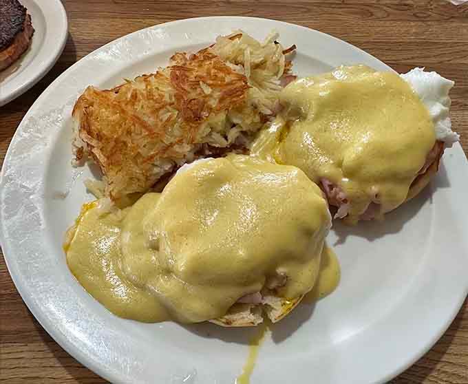 Eggs Benedict smothered in hollandaise with perfectly crisp hash browns deserves its own fan club.