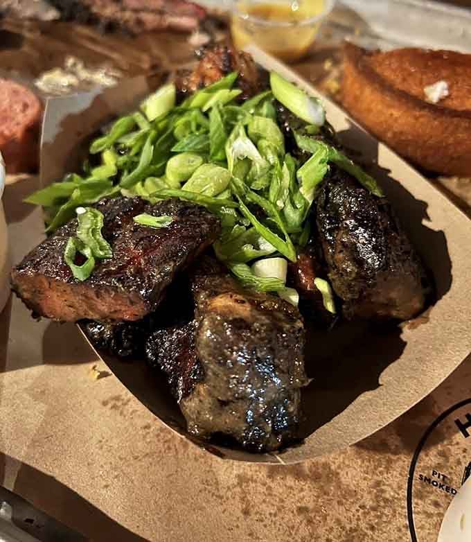Jerk rib tips glistening with glaze and topped with fresh scallions bring Caribbean heat to Brooklyn barbecue.