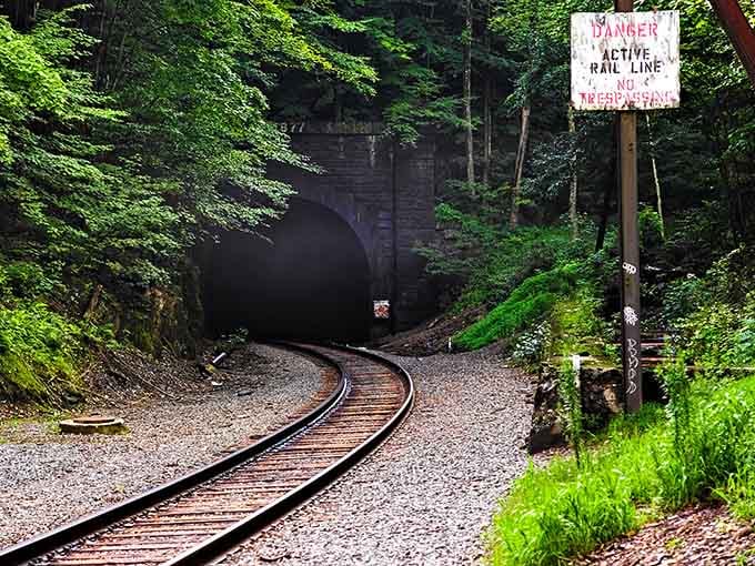 That warning sign isn't kidding around, freight trains still rumble through this historic passage daily without apologies.