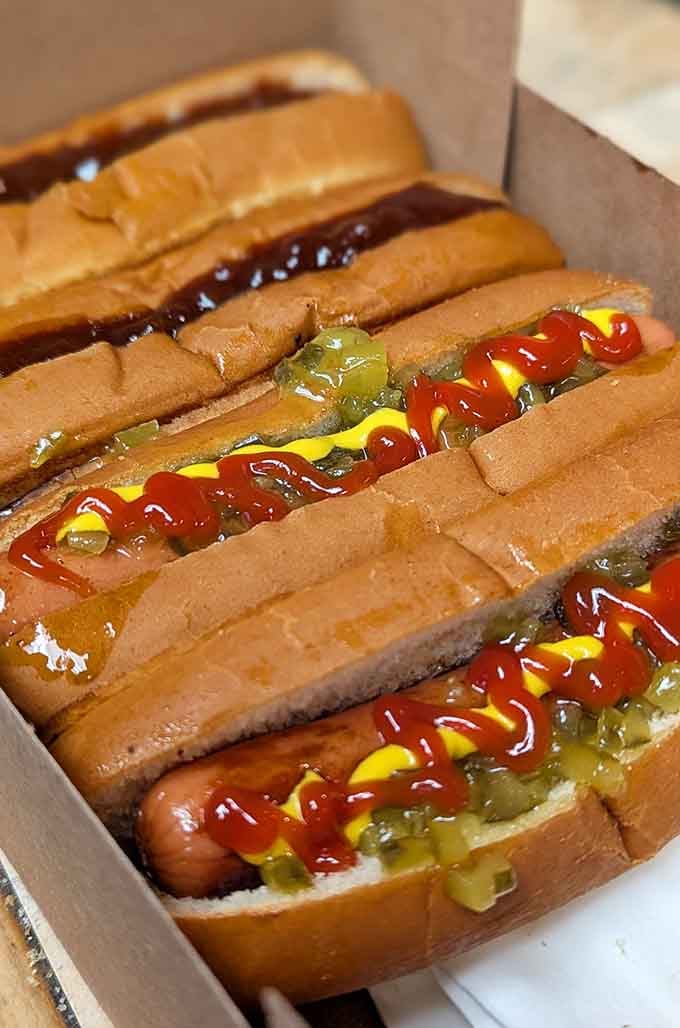 The holy trinity of condiments never looked so good nestled in those perfectly grilled buns.