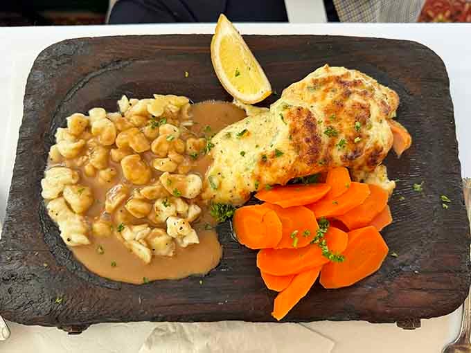 Parmesan crusted salmon on a sizzling platter, because even German restaurants know how to make seafood lovers feel welcome and appreciated.