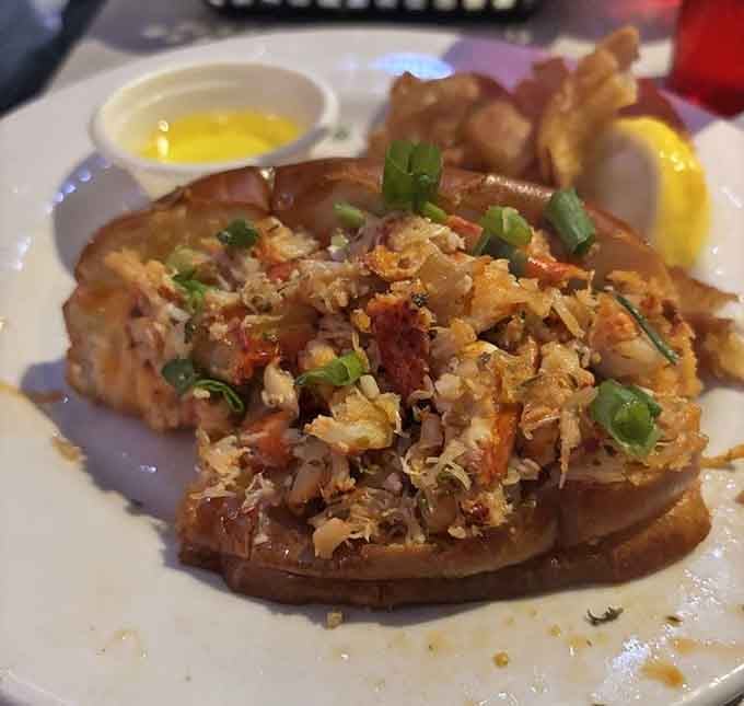 That lobster roll is packed with sweet meat and topped with what appears to be pure deliciousness in sauce form.