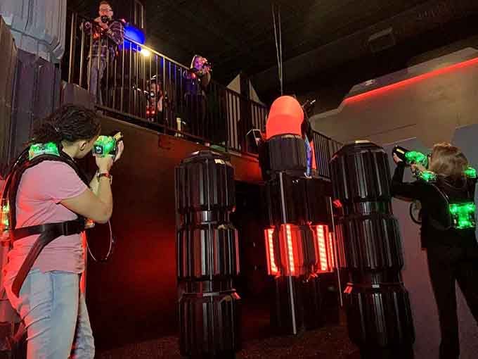 Laser tag gear glows red as families strategize their next move in this tactical entertainment arena.