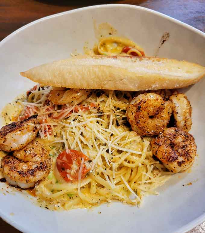 Blackened shrimp over pasta with garlic bread is comfort food that happens to come from the ocean instead.