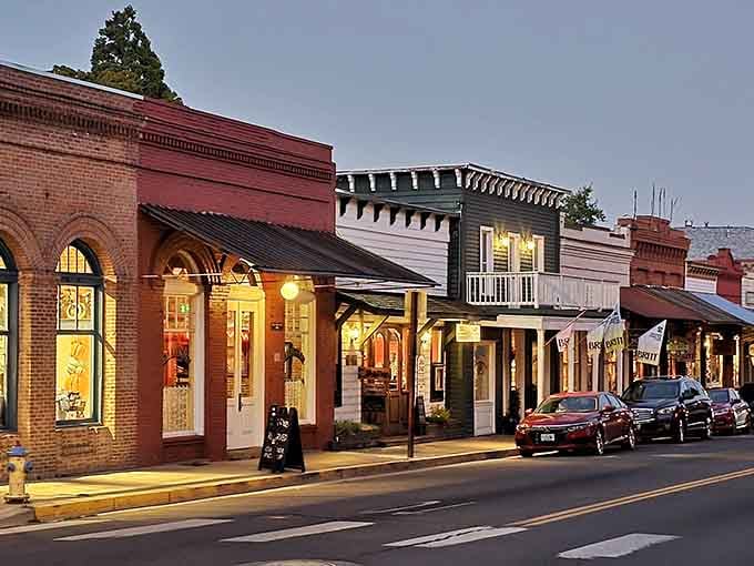 Evening lights illuminate storefronts that have been welcoming customers since your great-grandparents were considered young and reckless troublemakers.