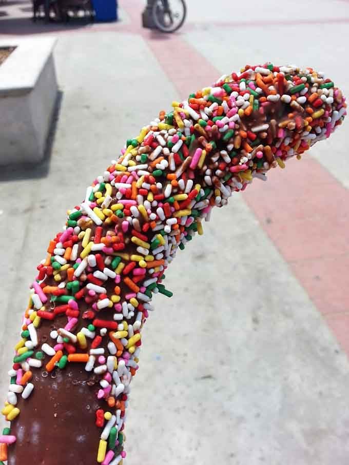 Frozen bananas dressed in chocolate and rainbow sprinkles, because sometimes you need dessert on a stick too.