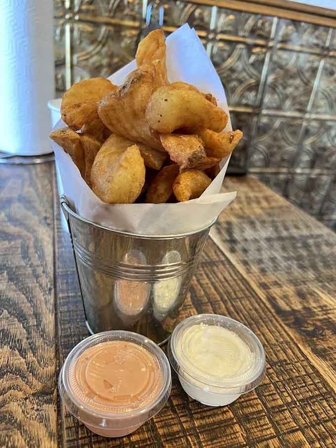 Sidewinder fries served bucket-style with dipping sauces, making sharing optional and highly unlikely to happen.