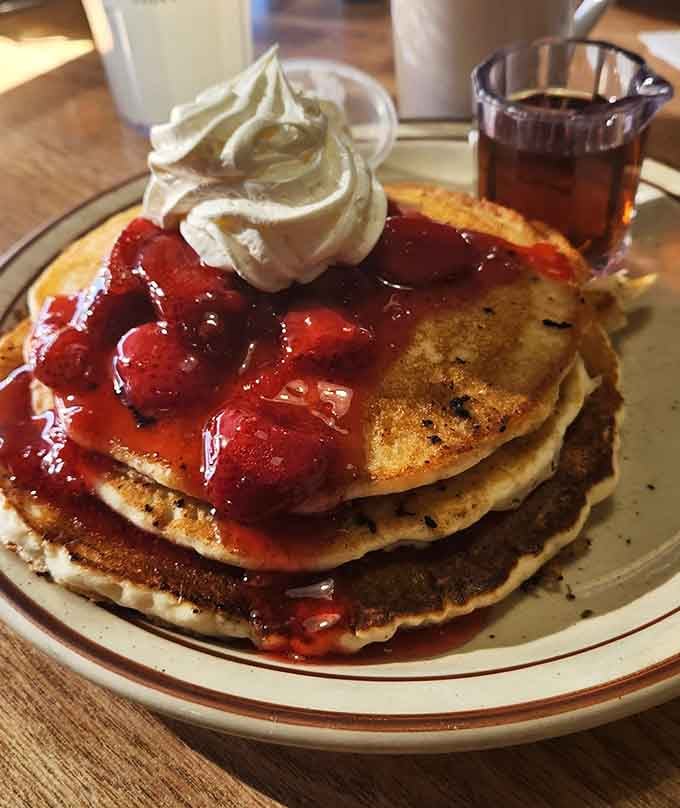 Fluffy pancakes topped with strawberries and whipped cream make mornings worth waking up for, honestly.