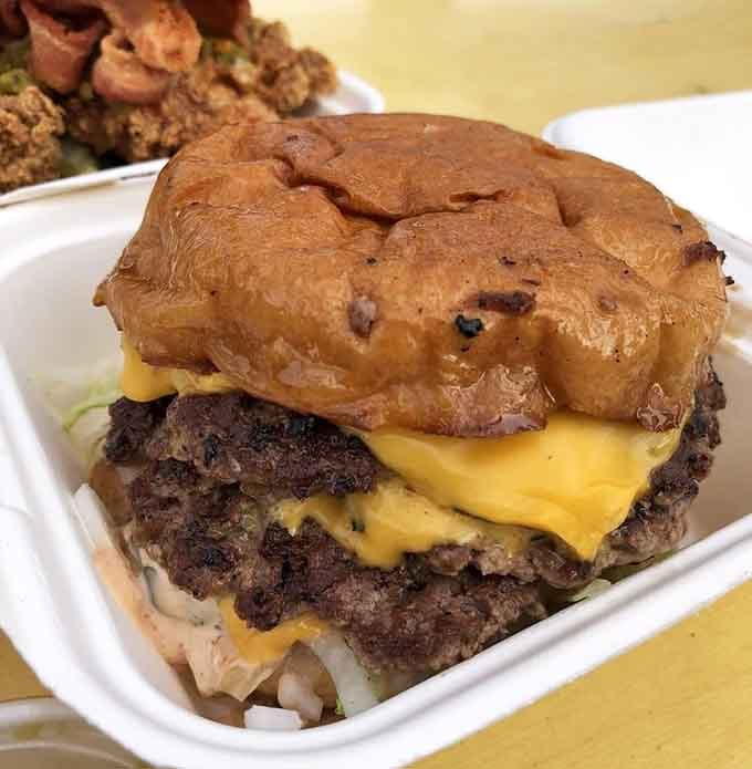 That double-stacked cheeseburger on a glazed bun is making some bold choices, and we're absolutely here for it.