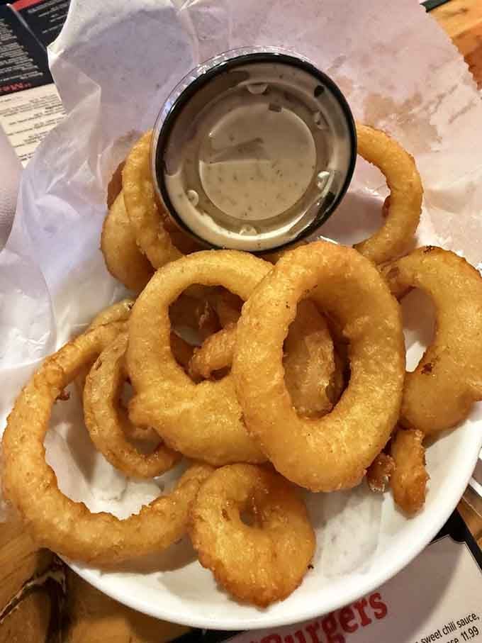 Onion rings so perfectly crispy they could double as edible architecture, if you weren't too busy devouring them.