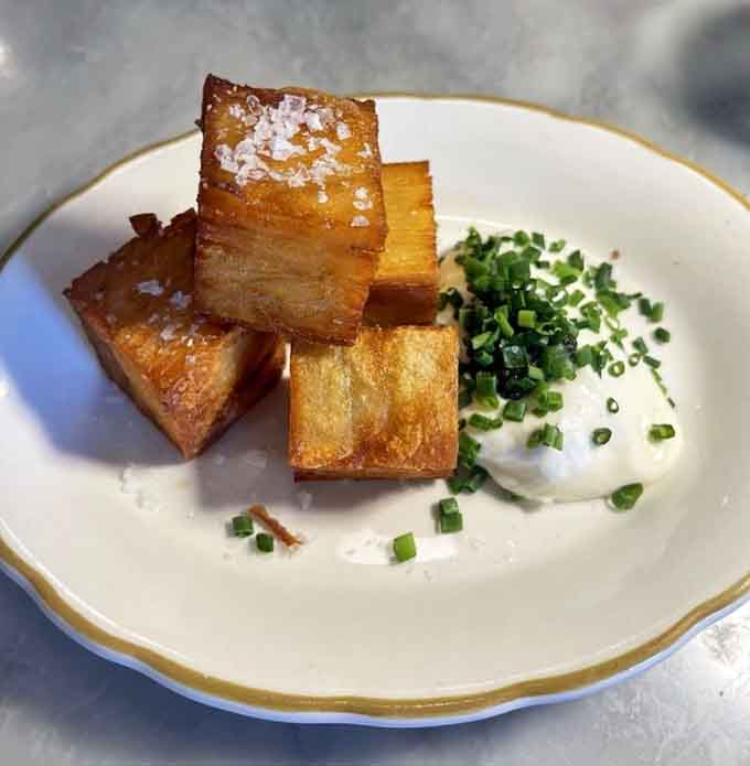 Crispy golden potato cubes with sea salt flakes are basically edible architecture on a plate.